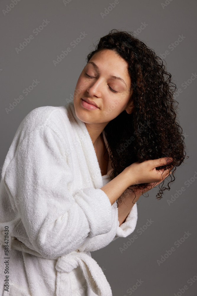 Lady touching hair after daily routine procedures Stock Photo | Adobe Stock