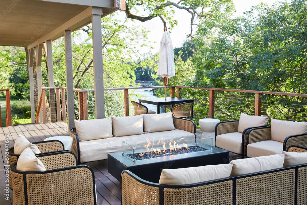 Outdoor lounge sofa furniture on deck with fireplace at luxury hotel ...