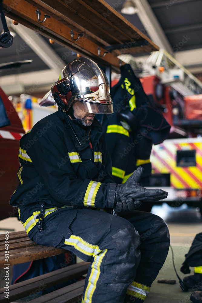 Firefighters putting on uniform Stock Photo | Adobe Stock
