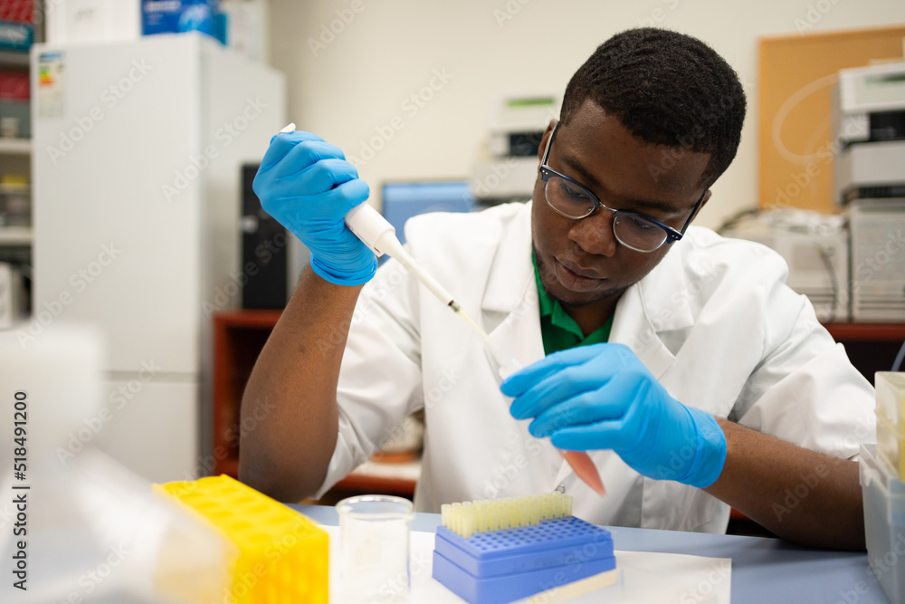 Black Man Scientist Focused Using The Pipette In The Lab. Stock Photo ...
