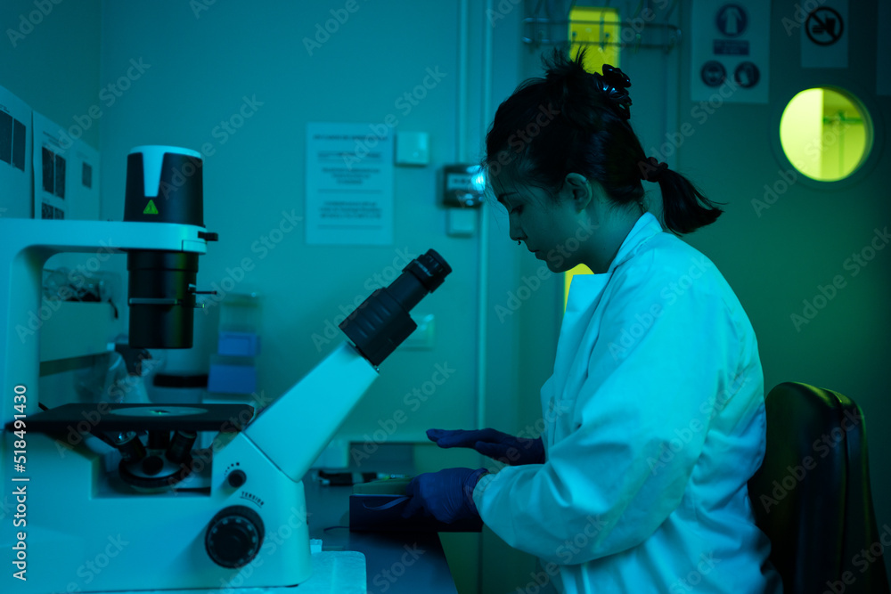 Profile Of A Young Scientist Using A Microscope in The Laboratory ...