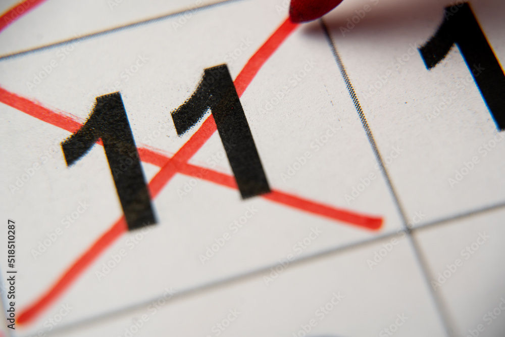 The 11st number in the calendar is crossed out with a red cross in a ...