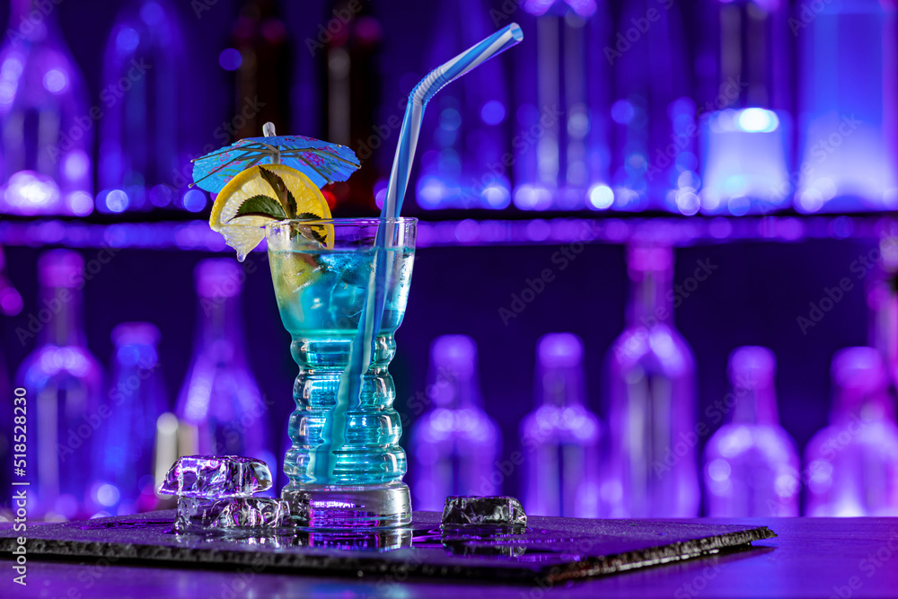 Cocktail Blue Lagoon, ice on bar counter in a restaurant, pub. Fresh ...