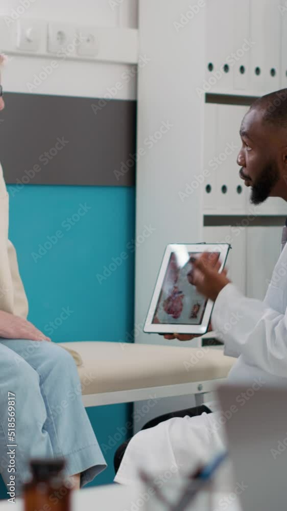 Vertical video: Cardiology medic showing cardiogram diagnosis on ...