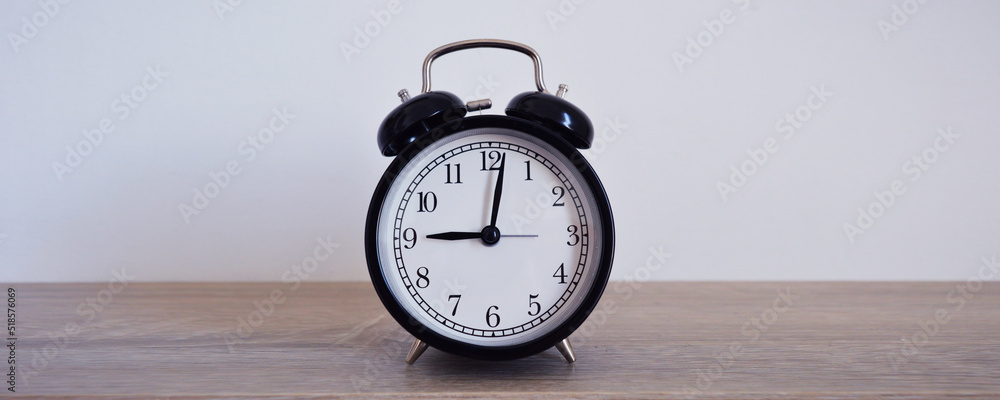 Analog alarm clock pointing at hours, minutes, seconds to display time ...