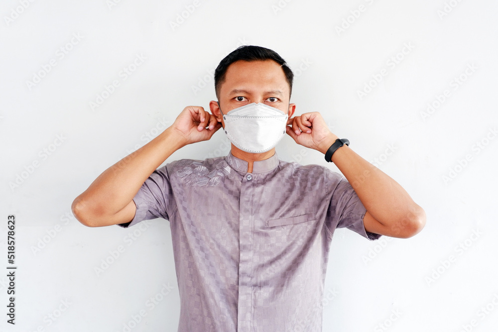 Asian man shows how to wear a mask isolated on white background. Stock ...