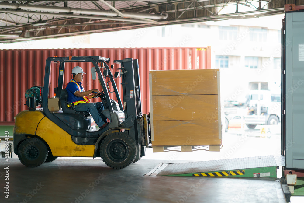 Forklift are loading into cargo containers at warehouses, ports ...