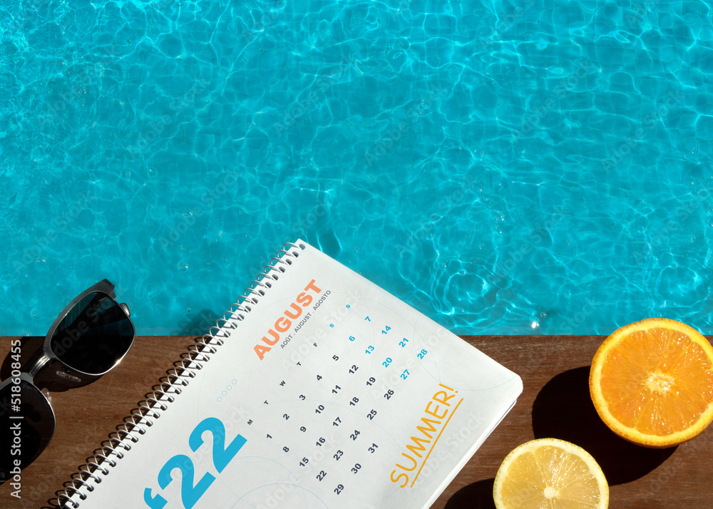 Top view of swimming pool with orange, lemon, sunglass and calendar on ...