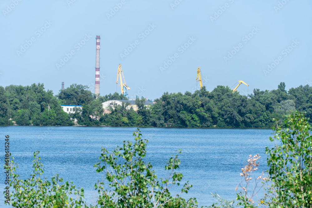 Big port cranes on the river. Extraction and transportation sand ...