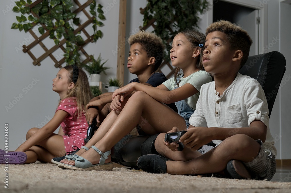 Pretty multi-national kids playing gaming console at home - virtual ...