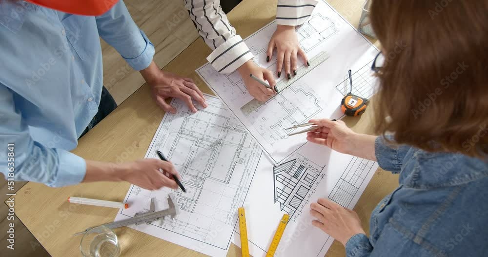 A team of architects plan and develop sketch design drawings of a ...