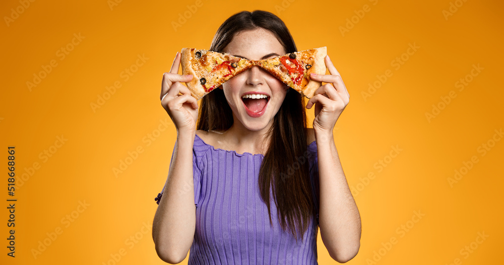 Happy smiling woman holding pizza slices on eyes with excited face ...