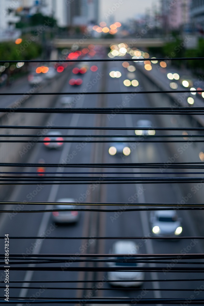 electrical and communication overhead cables agains street with car ...