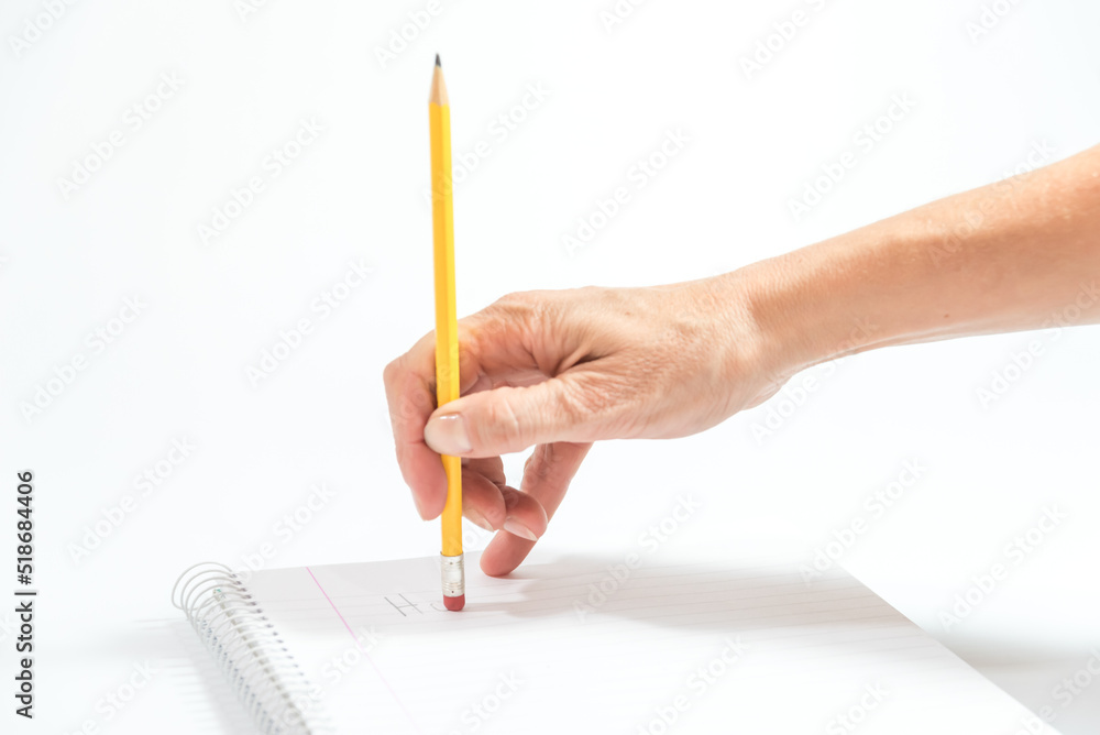 hand erasing with the rubber of a pencil a sheet of a notebook Stock ...