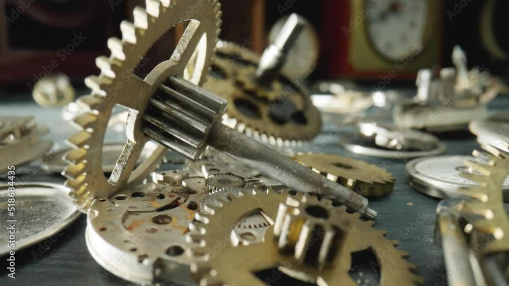 Pile of metal internal parts of an old clock. Dial, clockwork, bracelet ...