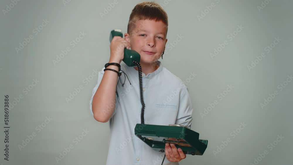 Hey you, call me back. Portrait of toddler kid boy talking on wired ...