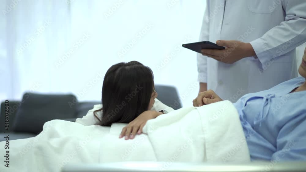 Hopeless Asian young woman crying beside her mother who resting in the ...