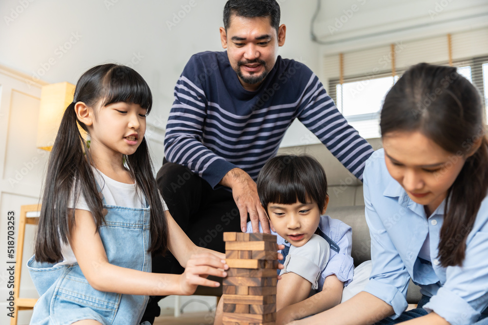 Happy asian family dad and child son building constructor from blocks.Loving parents having fun ...