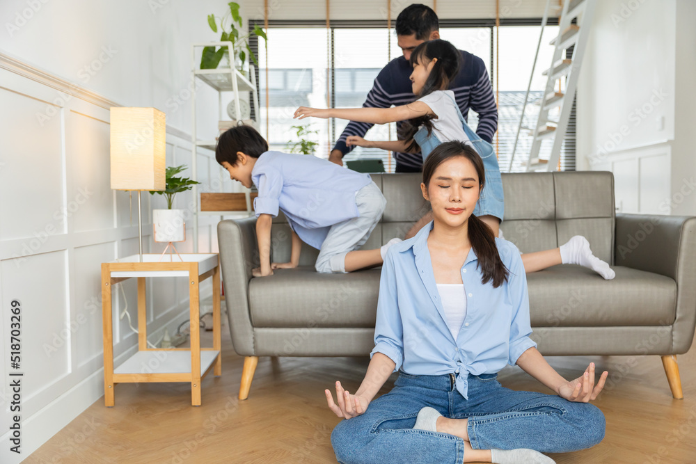 Asian woman with cute funny kid daughter doing yoga exercise at home ...
