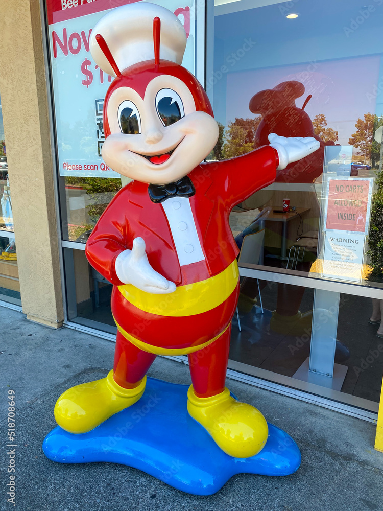 Jollibee mascot stood outside a restaurant. Stock Photo | Adobe Stock