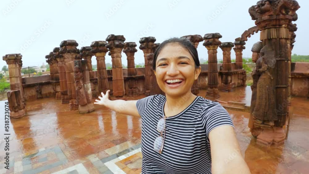 4K portrait of young Indian woman travel vlogger vlogging at old ...