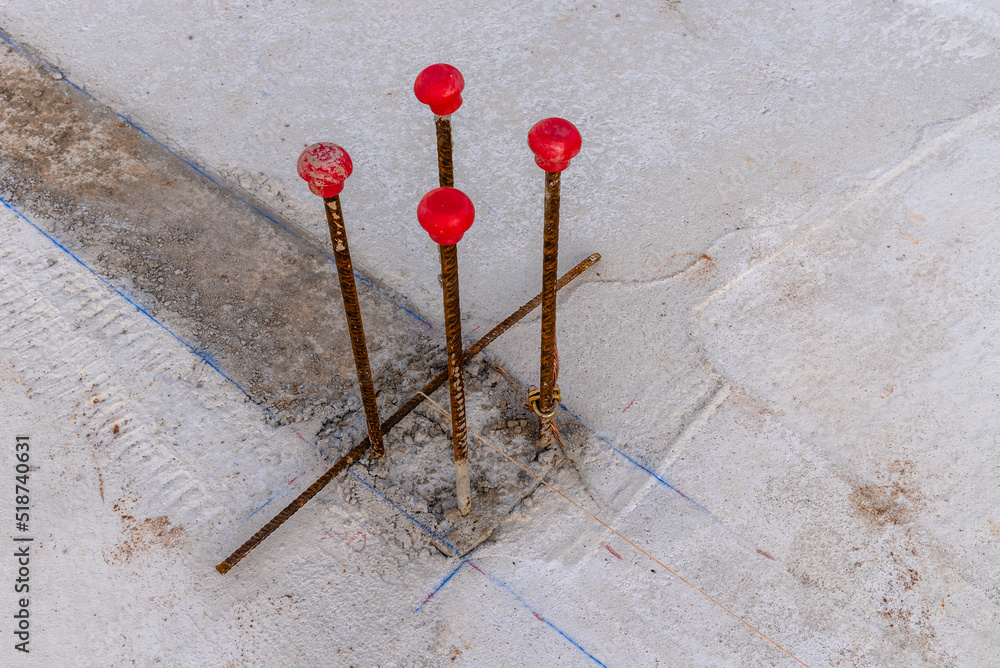 Pillar rebars with plastic caps. Construction site with steel ...