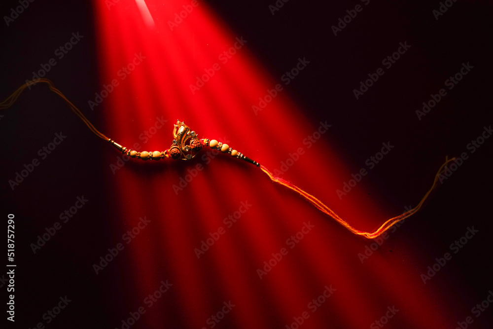 Indian festival: Raksha Bandhan. A traditional Indian wrist band on red ...