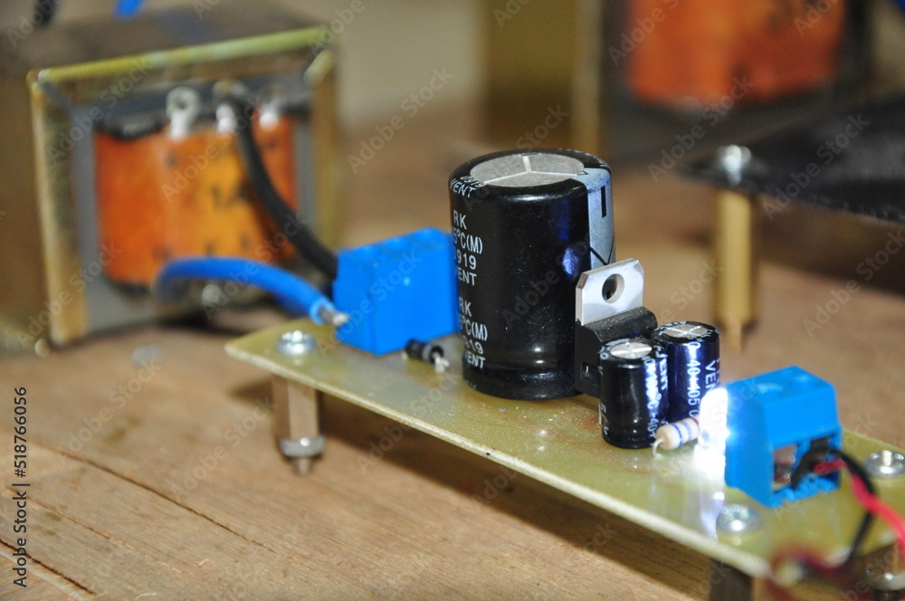 black electrolytic capacitor and regulator IC in the voltage converter ...