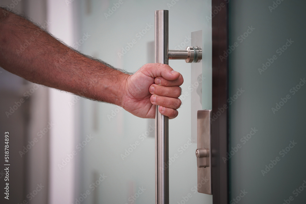 Male hand open the office glass door. Male hand open door knob. Man ...