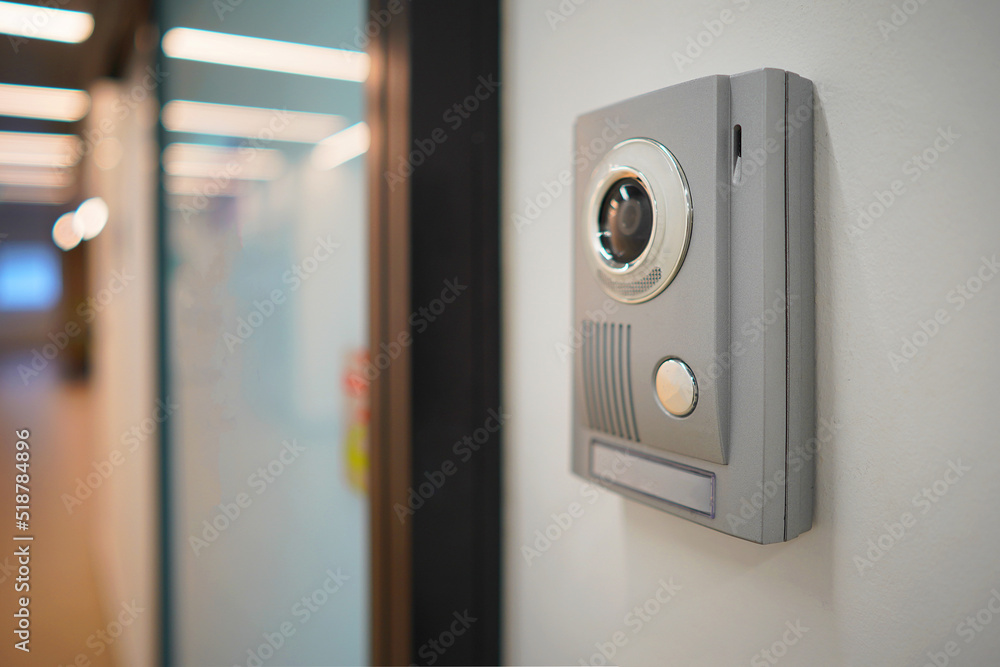 Video intercom system on white wall to enter office. Intercum with a ...