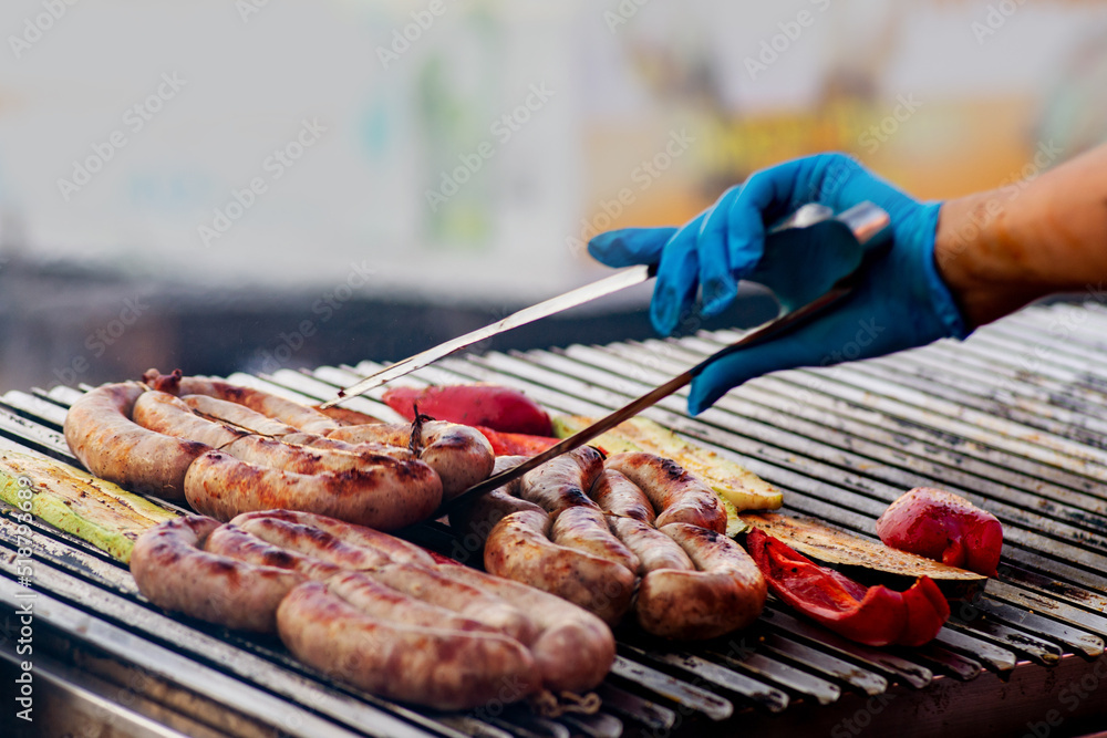BBQ sausages are grilled over an open fire. Grilled sausages on a ...