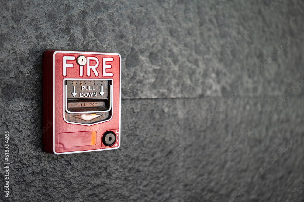 A fire alarm trigger box which is installed on building wall. Emergency ...