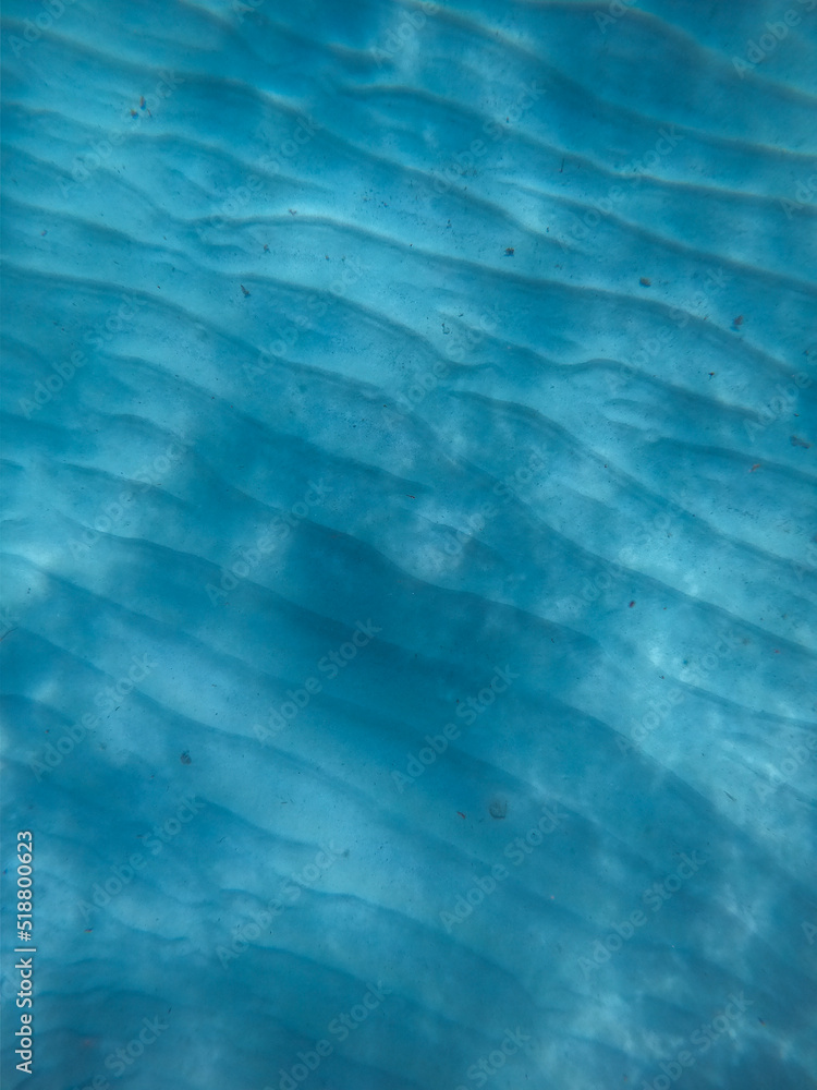 underwater scene with rays of light on a beach on the island of Majorca ...