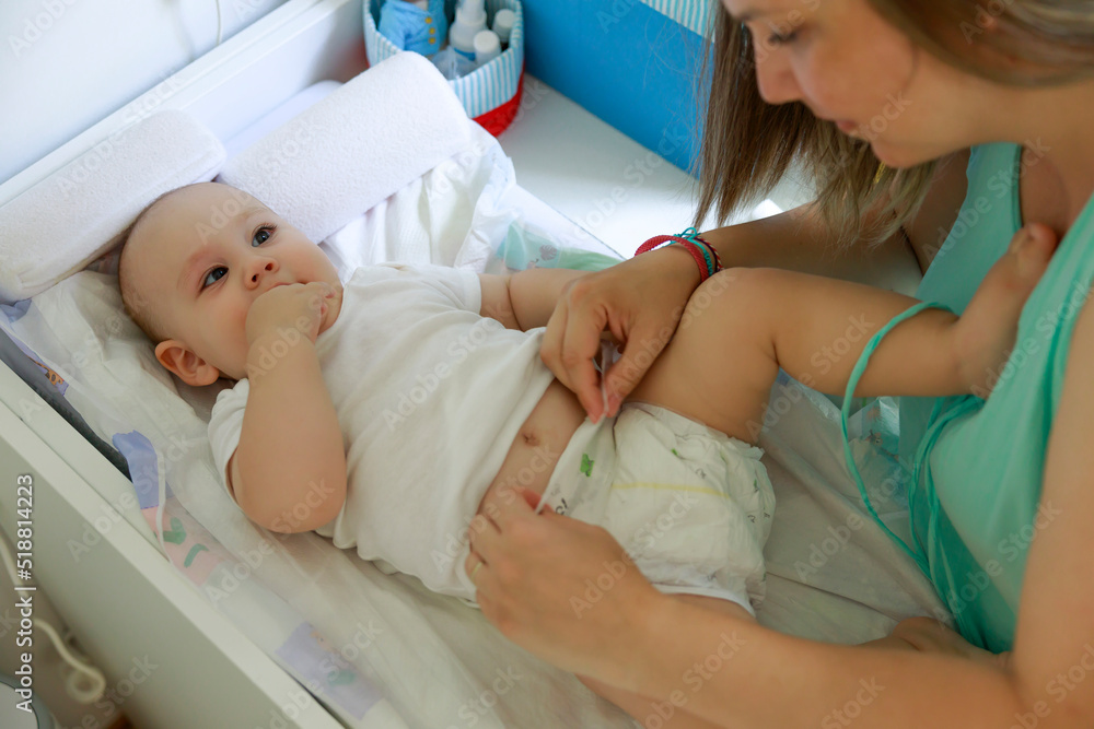 Cute baby in bedroom getting diaper changed Stock Photo | Adobe Stock