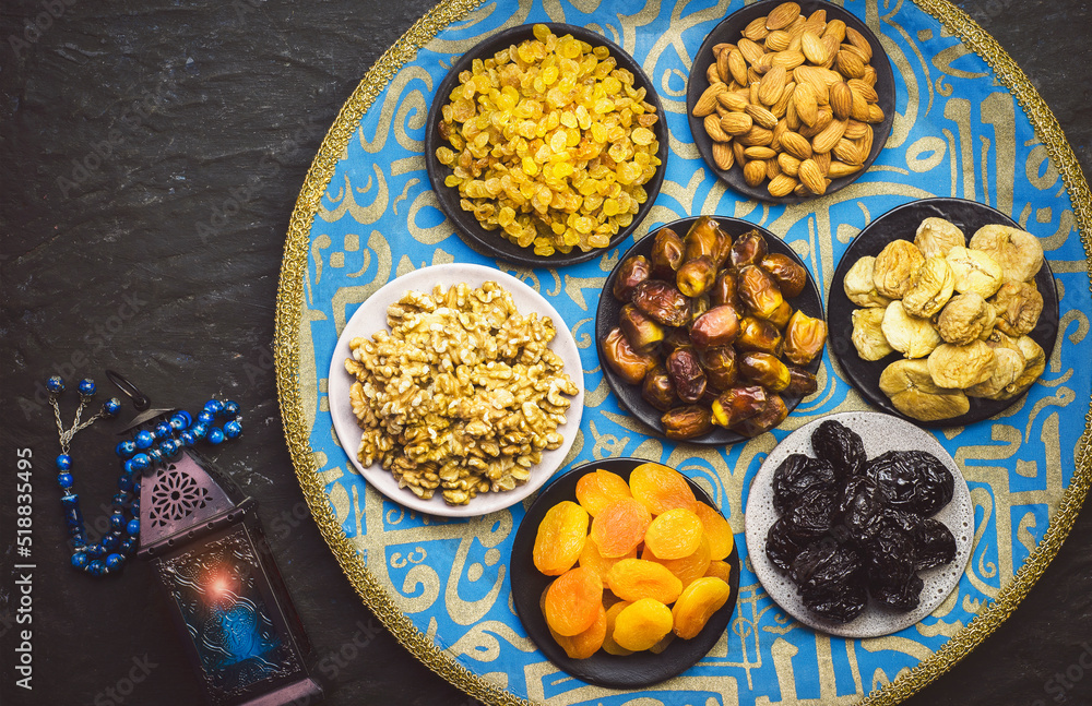Ramadan celebration. Mix of dried fruits, dates and nuts placed with ...