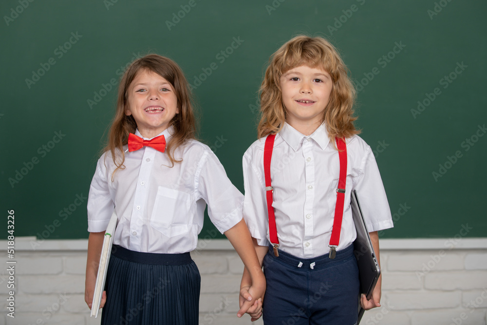 Friendly classmates in school uniform at lesson. Schoolkids and ...