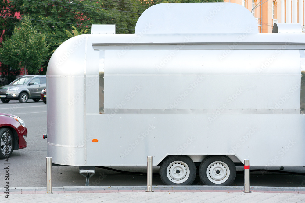 Closed rounded metal American caravan used as a mobile catering vehicle ...