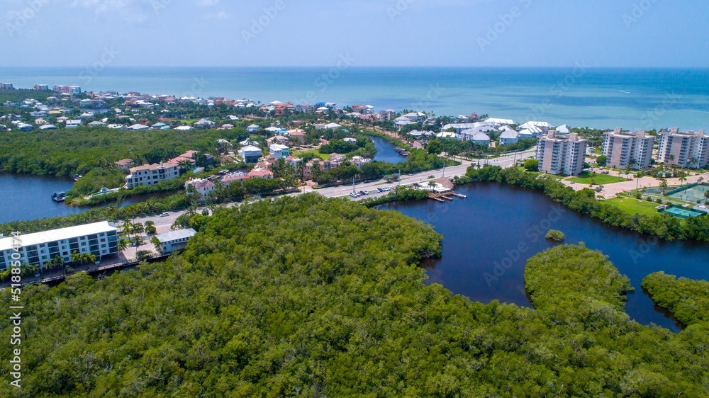 Aerial Drone View of Barefoot Beach in Bonita Springs, Florida. Real Estate with Blue Bay Waters ...
