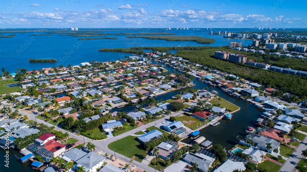 Aerial Drone View of Homes Featuring Canals on Blue Bay Waters ...