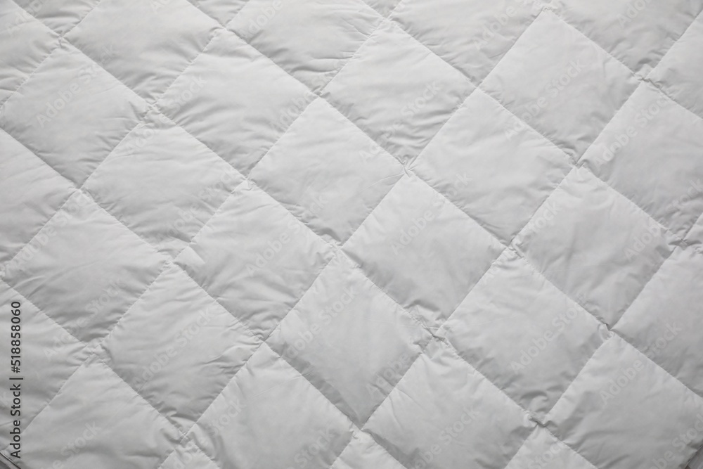 Soft quilted blanket as background, top view Stock-Foto | Adobe Stock