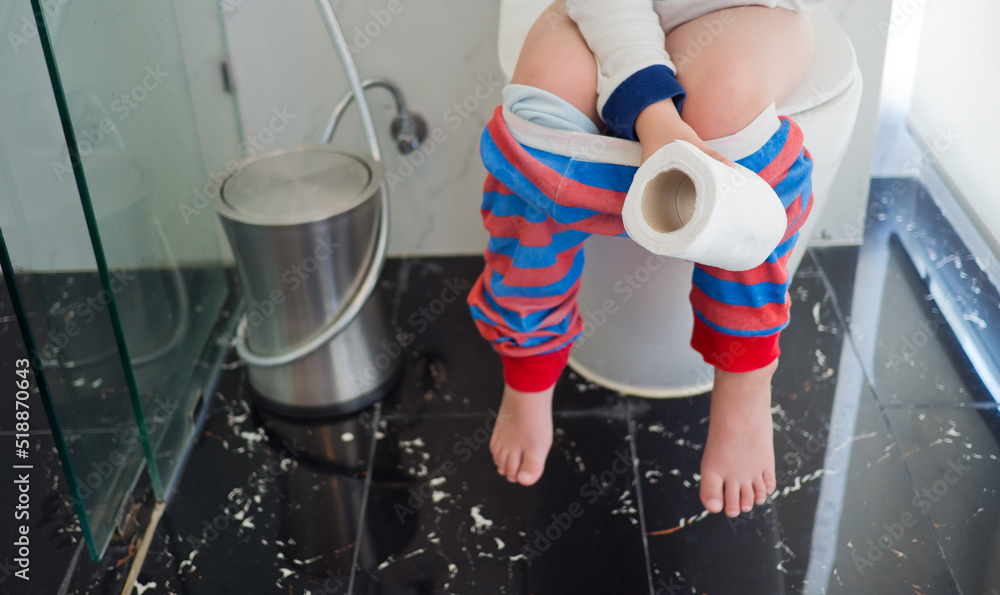 boy in the bathroom, sitting in the toilet Stock Photo | Adobe Stock