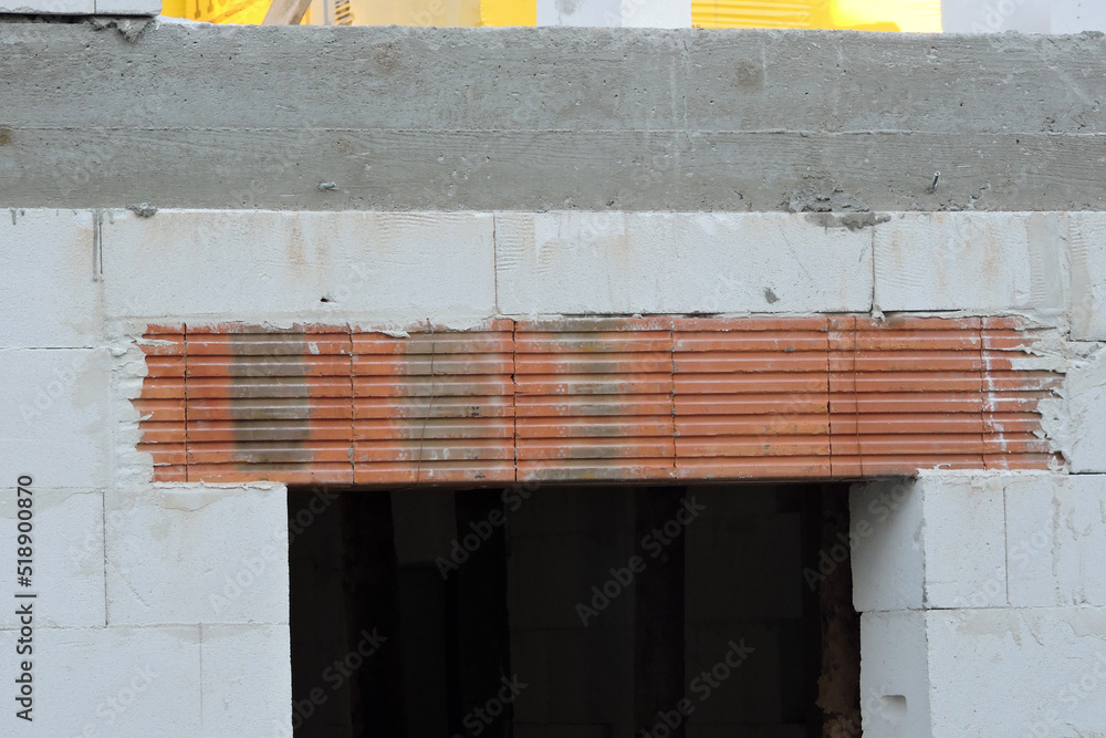 A reinforced brick lintel, a rough window opening and walls made of ...