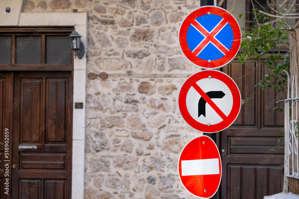 Small traffic signs with prohibitions on the background of buildings on ...