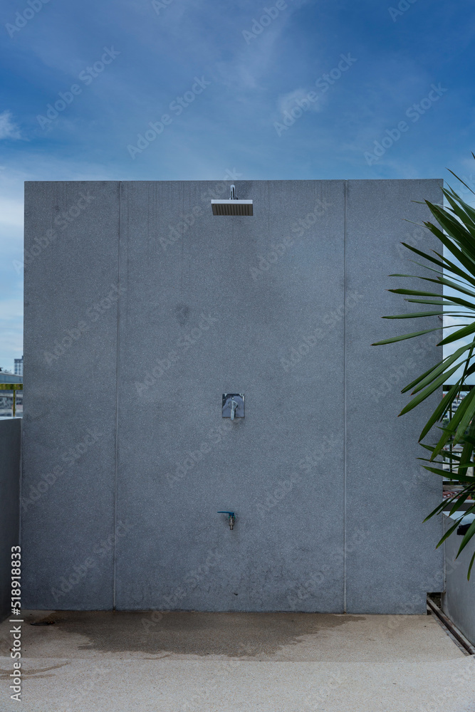 Outdoor shower at swimming pool. shower cabins behind outdoor swim pool ...