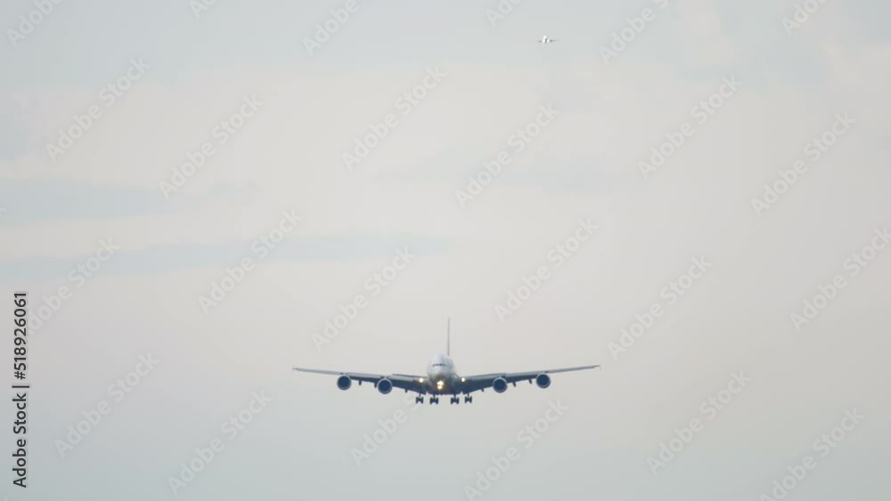 Long shot of a four-engine double-deck wide-body aircraft approaching ...