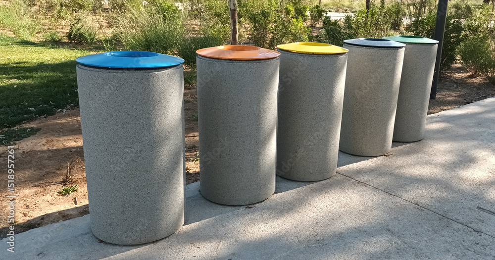 Colorful waste collection bins for paper, plastic, residual waste ...