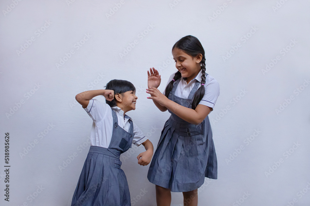 Indian school girls fighting playful Stock Photo | Adobe Stock