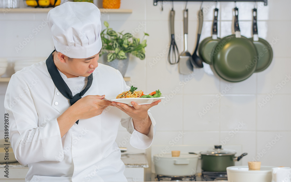 Portrait handsome Asian professional male chef wearing white uniform ...