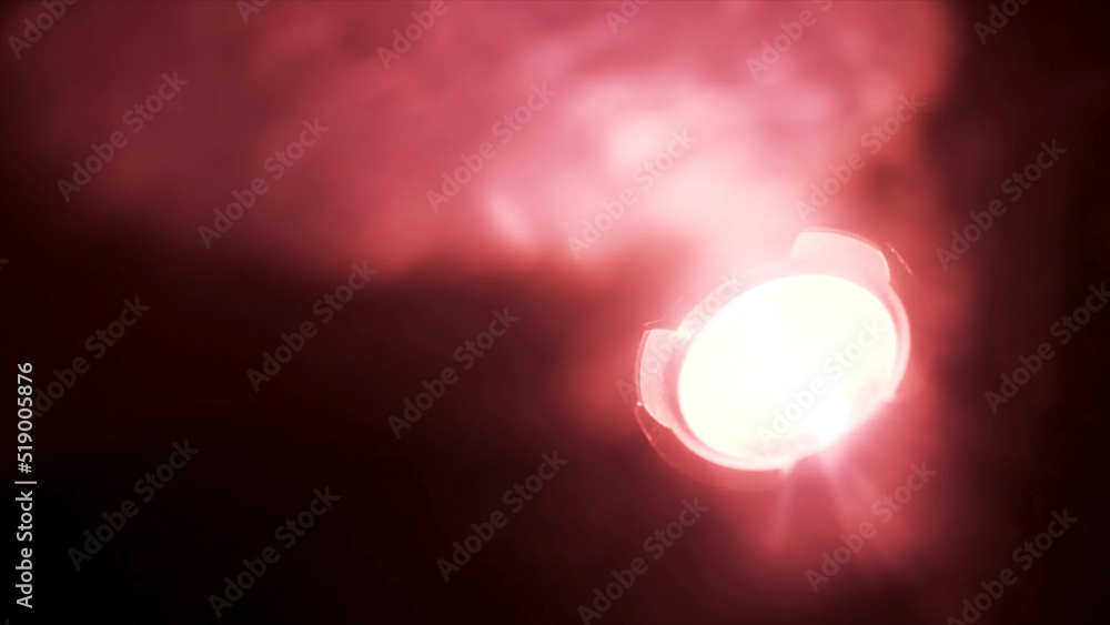 Close up of red spotlight blinking in complete darkness. Action. Red ...
