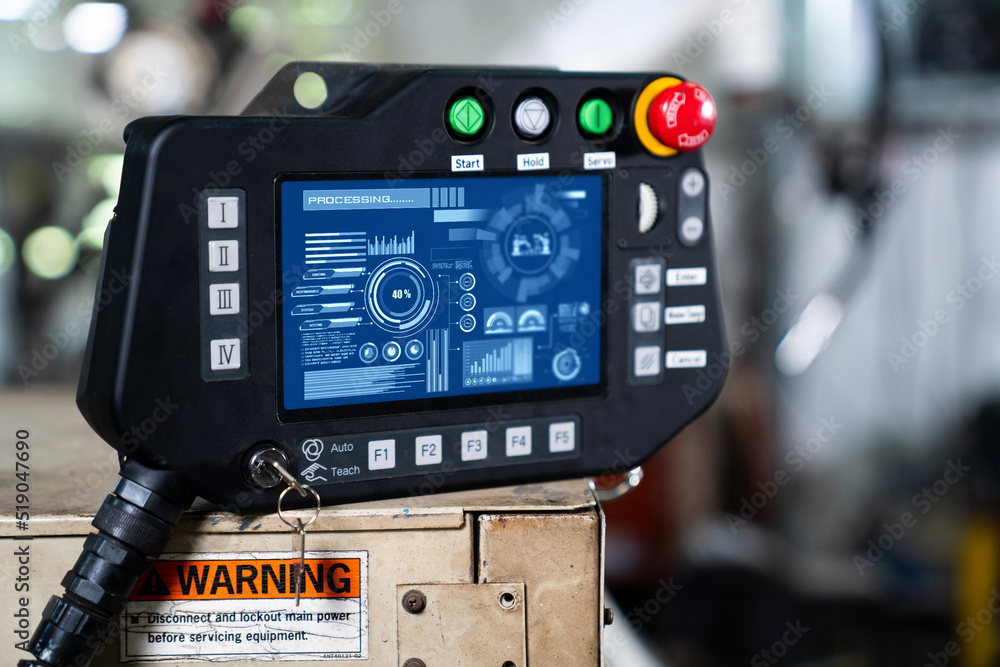 Robotic arm and its controller adept panel in a factory workshop ...